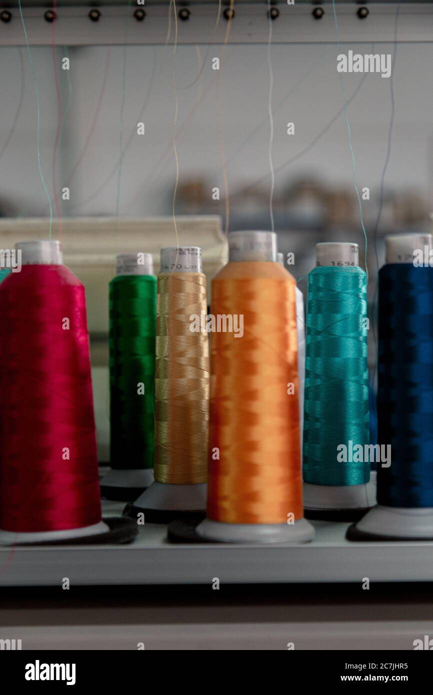 Lot of colorful sewing threads on the shelf in a tailors studio Stock ...