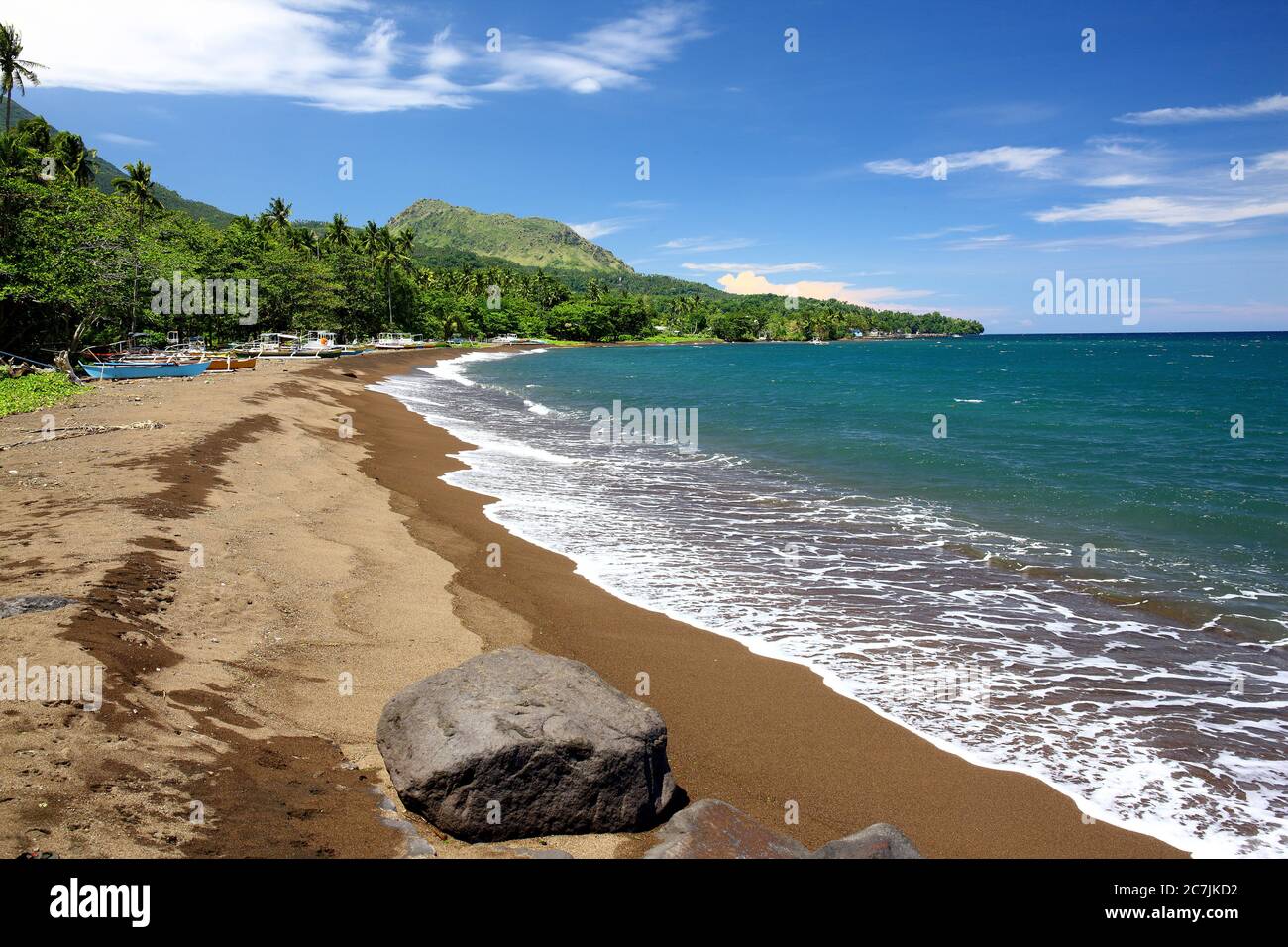 Half day on a Camiguin beach with boats in the foreground, Philippines ...