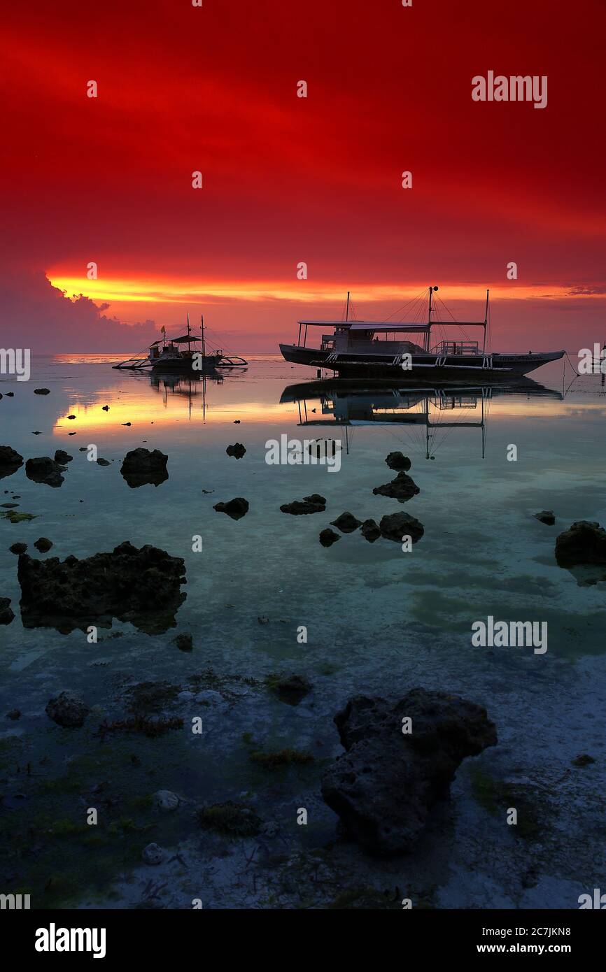 Outrigger traditional fishing boat moored on the beach on the east ...