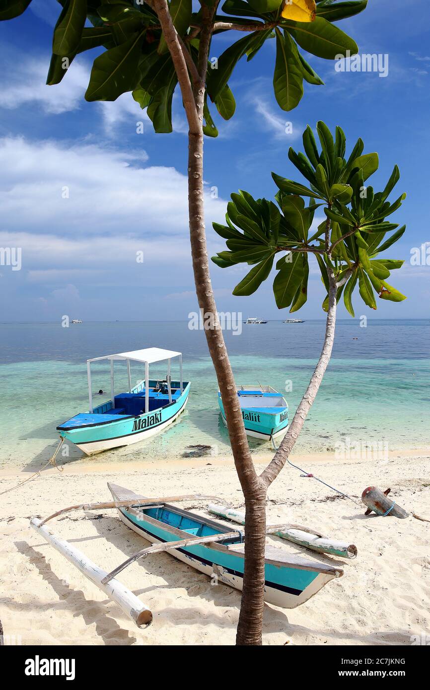 Outrigger traditional fishing boat moored on the beach on the east ...
