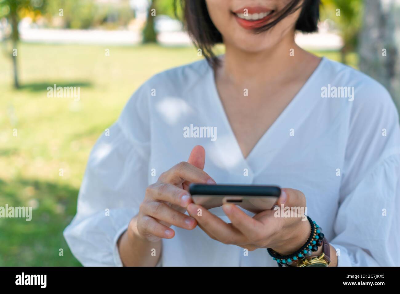 Woman happy and smile while use smartphone to do work business, social ...