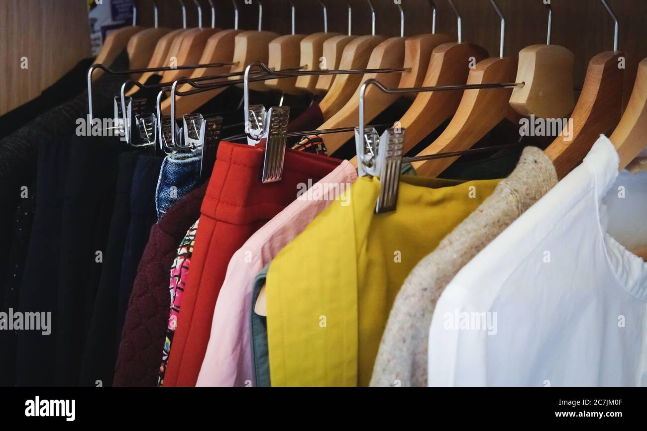 Lot of different clothes hanging in a wardrobe Stock Photo - Alamy