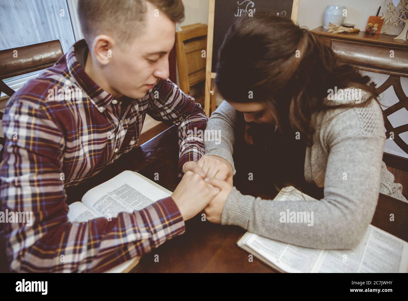 Couple holding hand under table hi-res stock photography and images - Alamy
