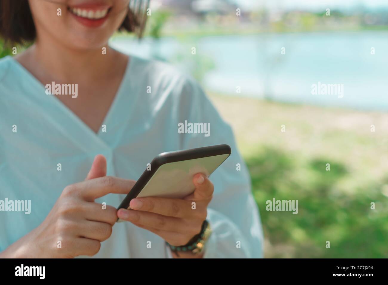 Woman happy and smile while use smartphone to do work business, social ...