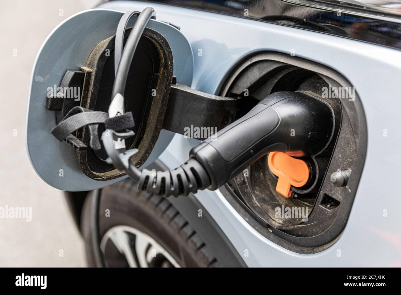 Electric car when charging, detail, loading flap, charging plug ...