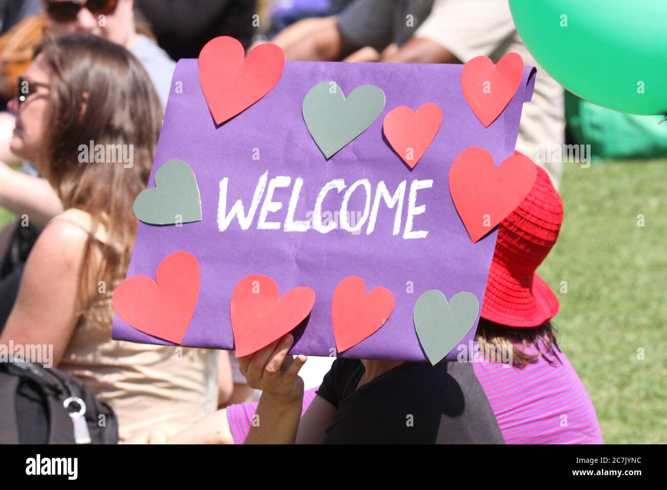 A sign saying, ‘Welcome’ is held at the ‘Walk Together’ celebration of ...