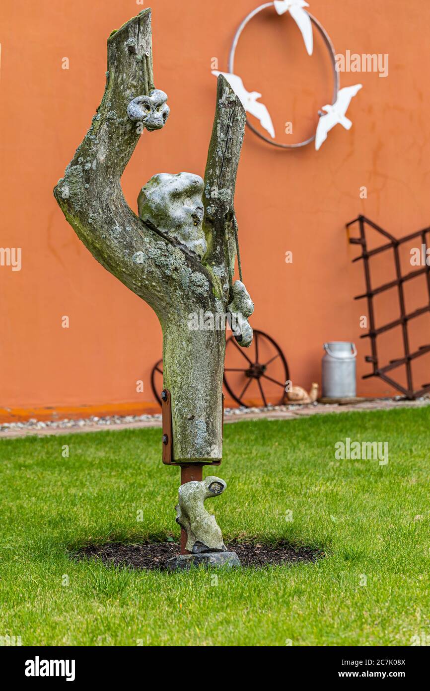 Garden decoration made of flint and driftwood Stock Photo - Alamy