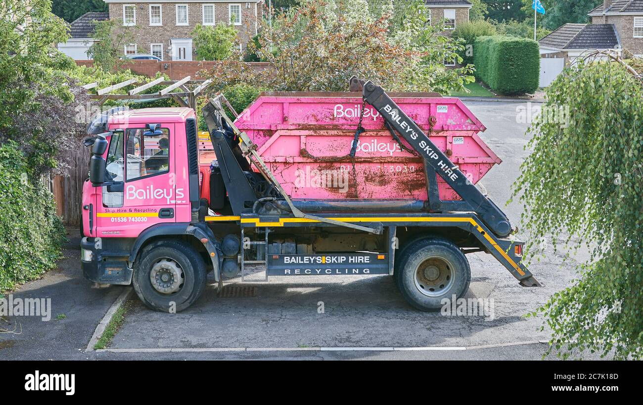 Pink coloured recycling and refuse skips on a Bailey's lorry Stock ...
