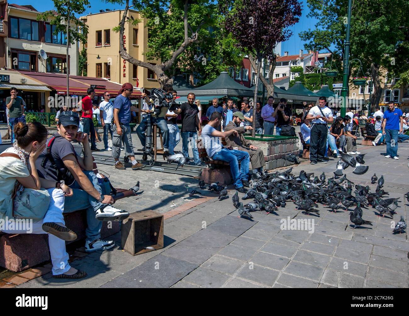 A crowd of people watch as the filming of a Turkish soap opera ...