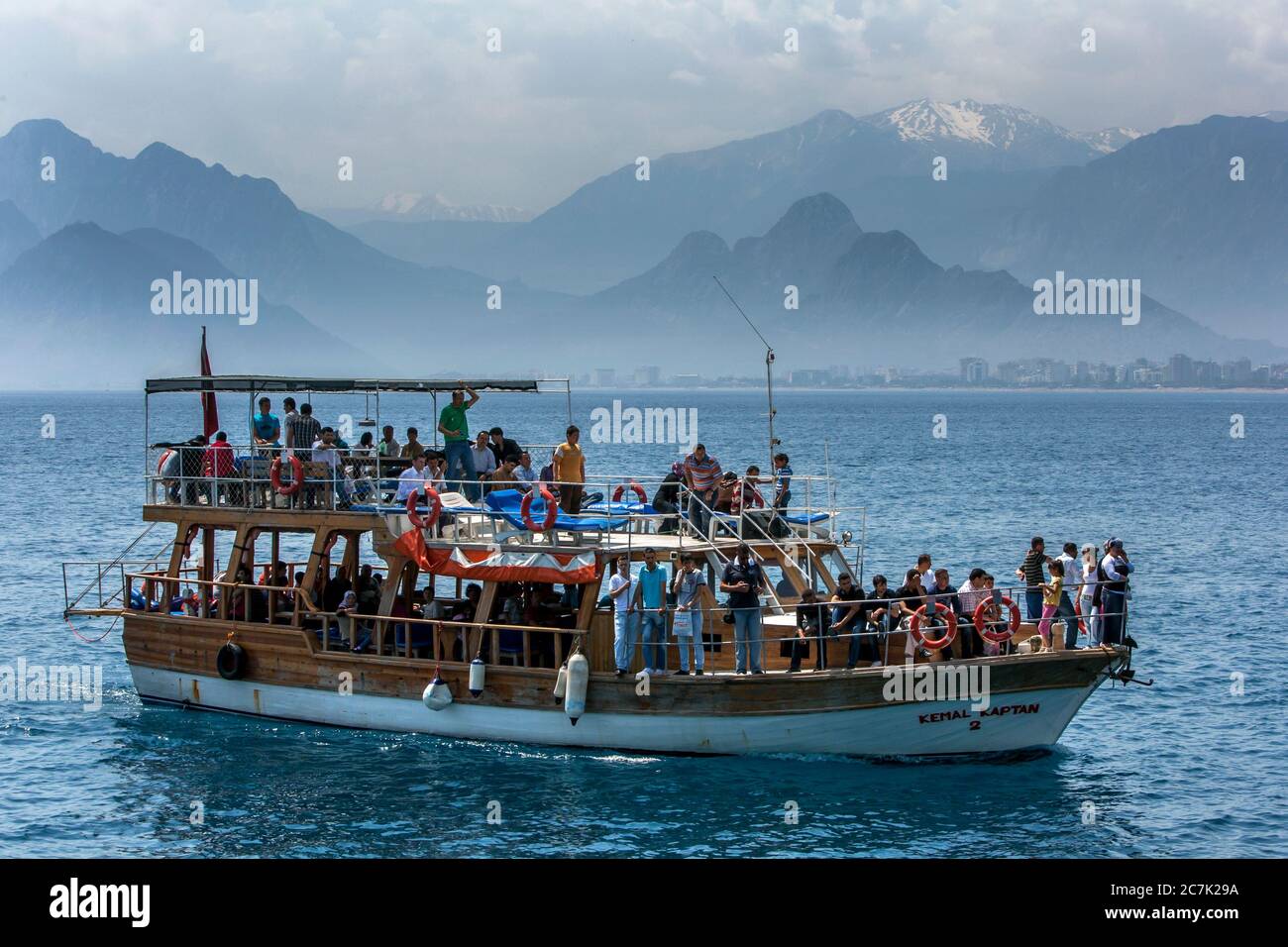 A cruise boat sails through Antalya Bay off Antalya in Turkey. In the ...
