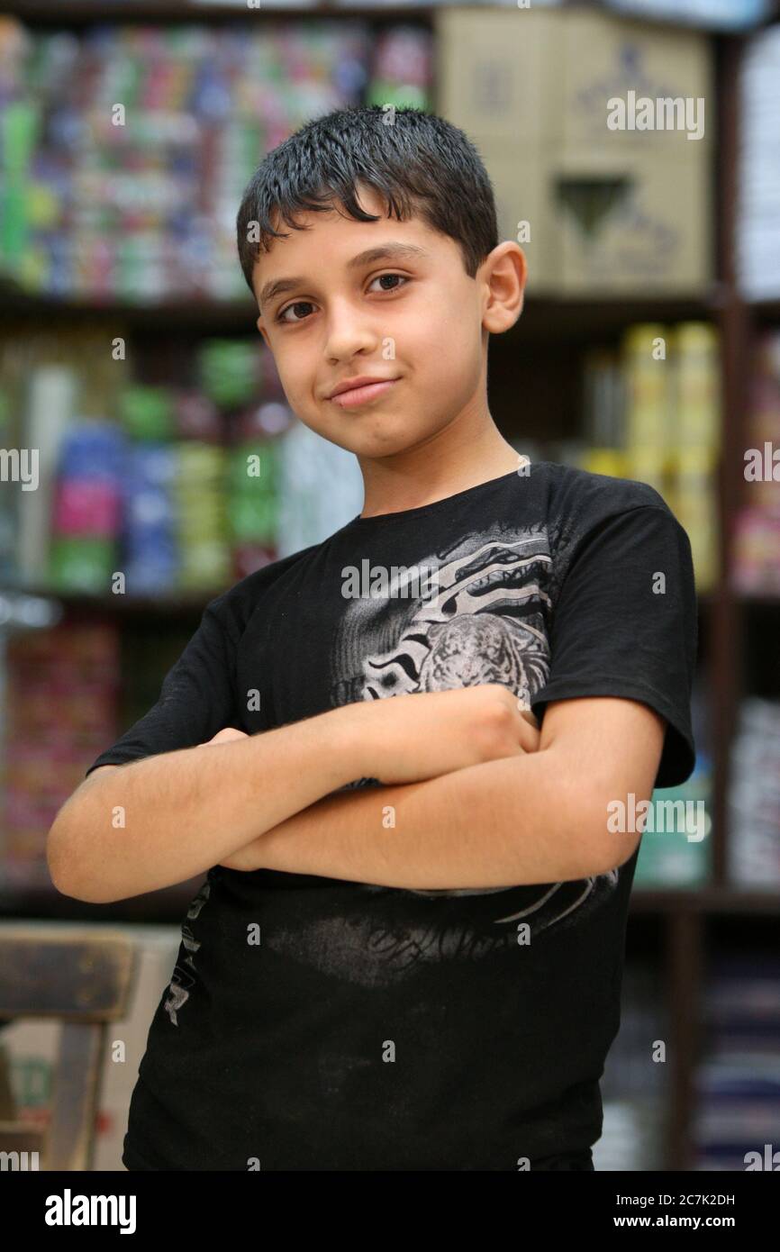 A portrait of a Kurdish boy standing in the Sanliurfa bazaar in south ...