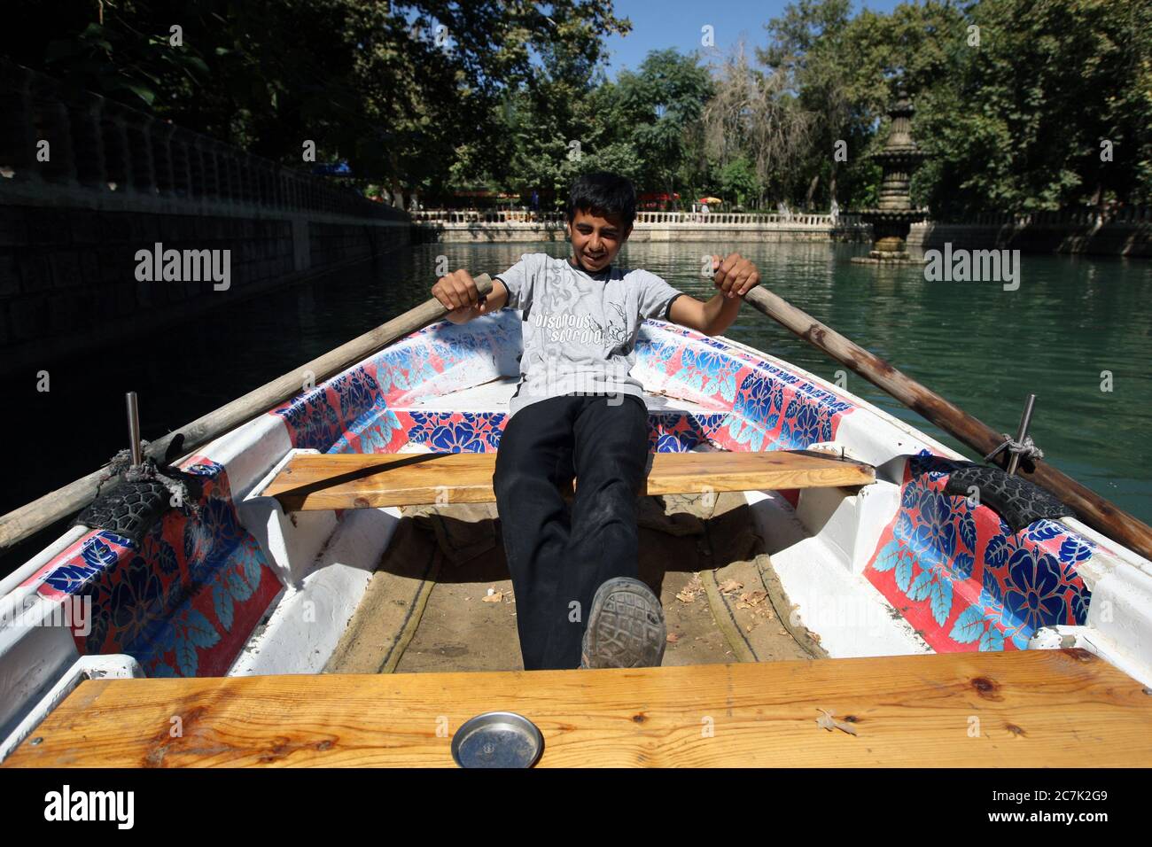 A Kurdish boy rows a boat around Ayn-i Zeliha, the second sacred pool ...