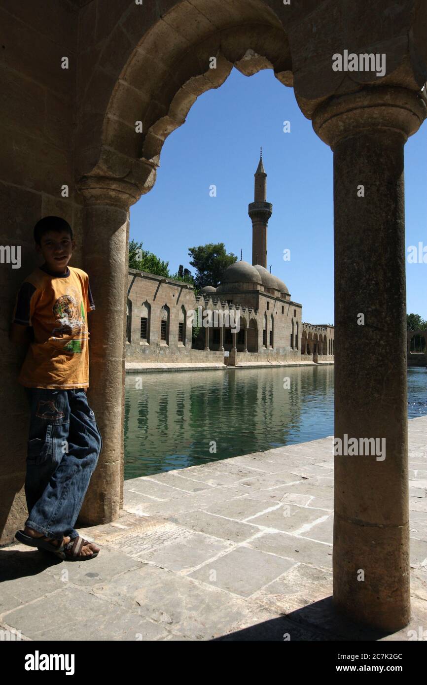 A Kurdish boy stands next to Balikli Gol (Pool of Sacred Fish) in ...