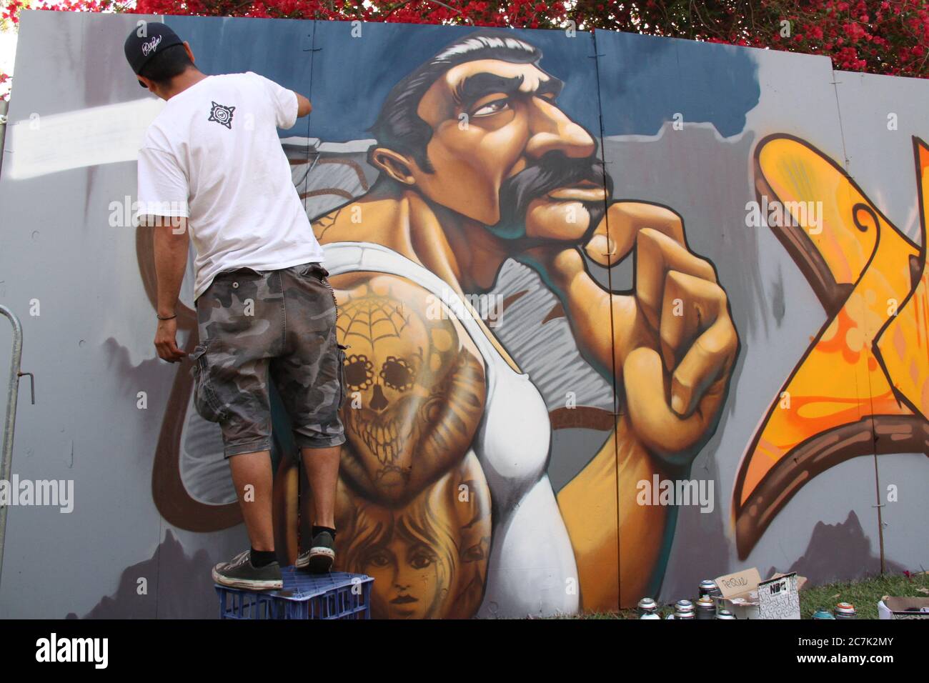 Graffiti Artists Phibs, Peque and Unique decorated a wall at the Live ...