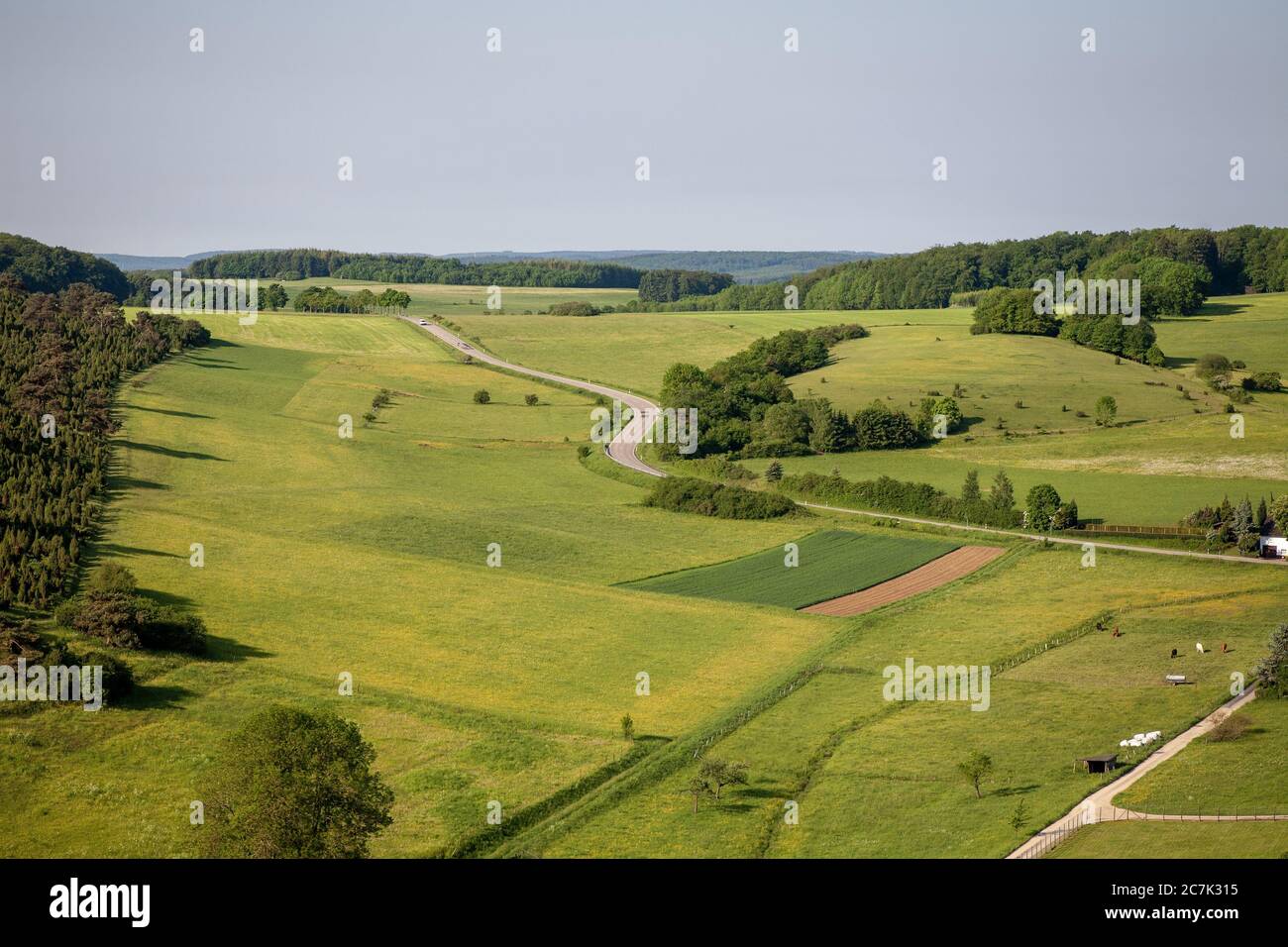 Aerial shot of farmland under the clear sky in the Eifel region ...
