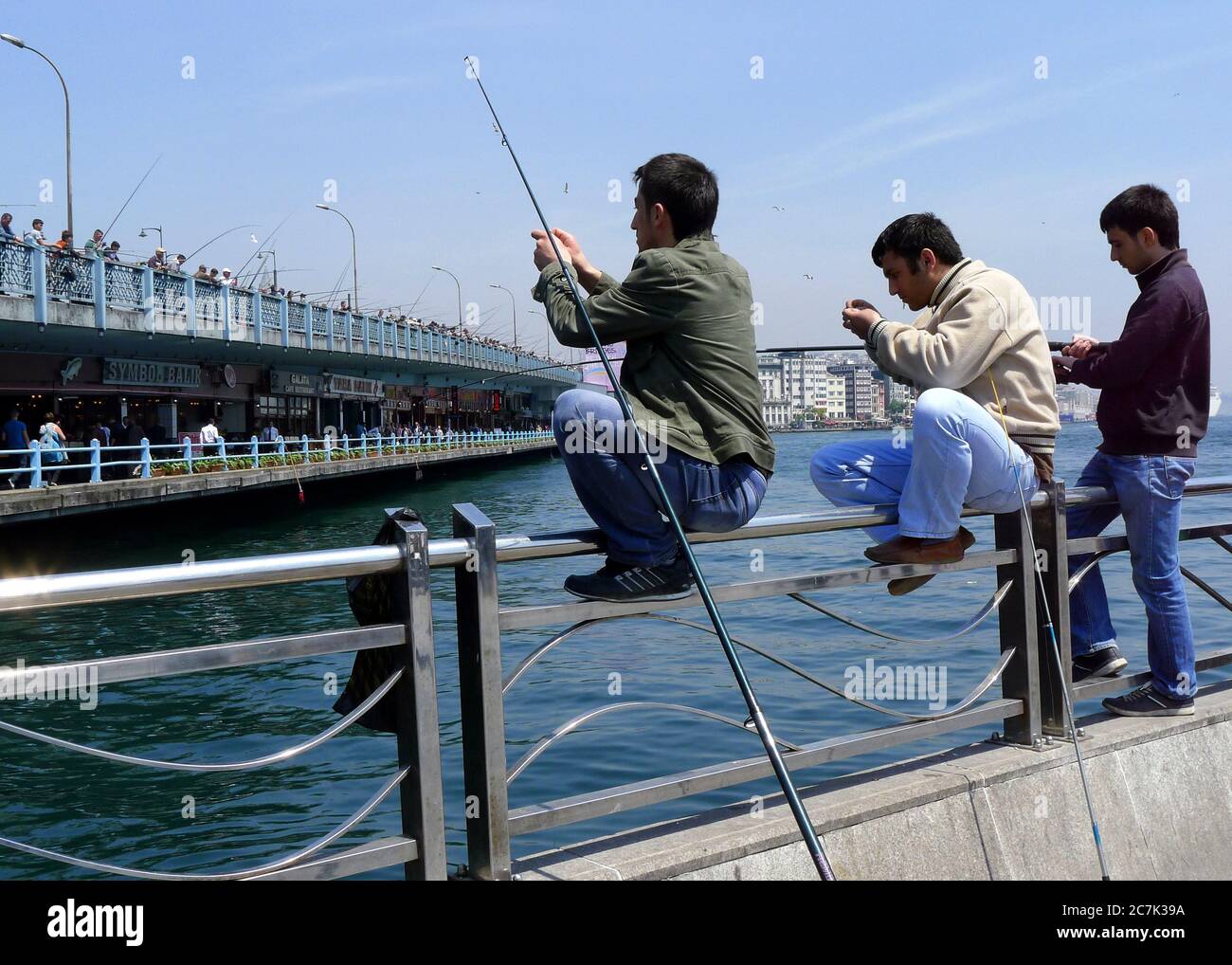 Fisherman bait their hooks next to Golden Horn at Eminonu in Istanbul ...