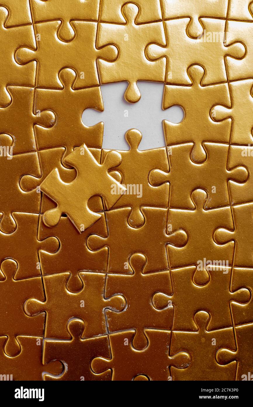 gold puzzles with one piece missing, flat lay. Nobody Stock Photo - Alamy