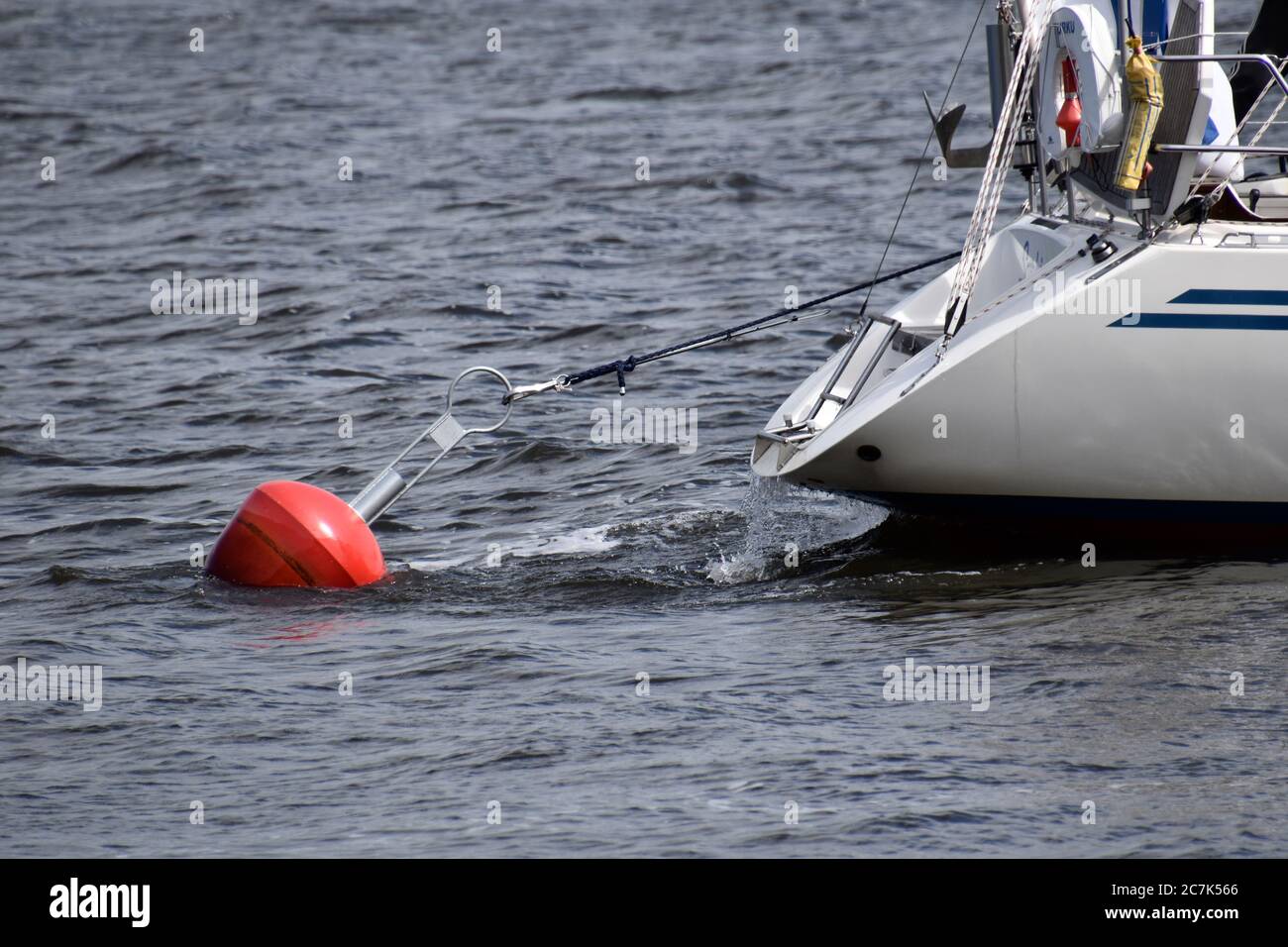 Red float attached to the end of a boat in the sea Stock Photo - Alamy