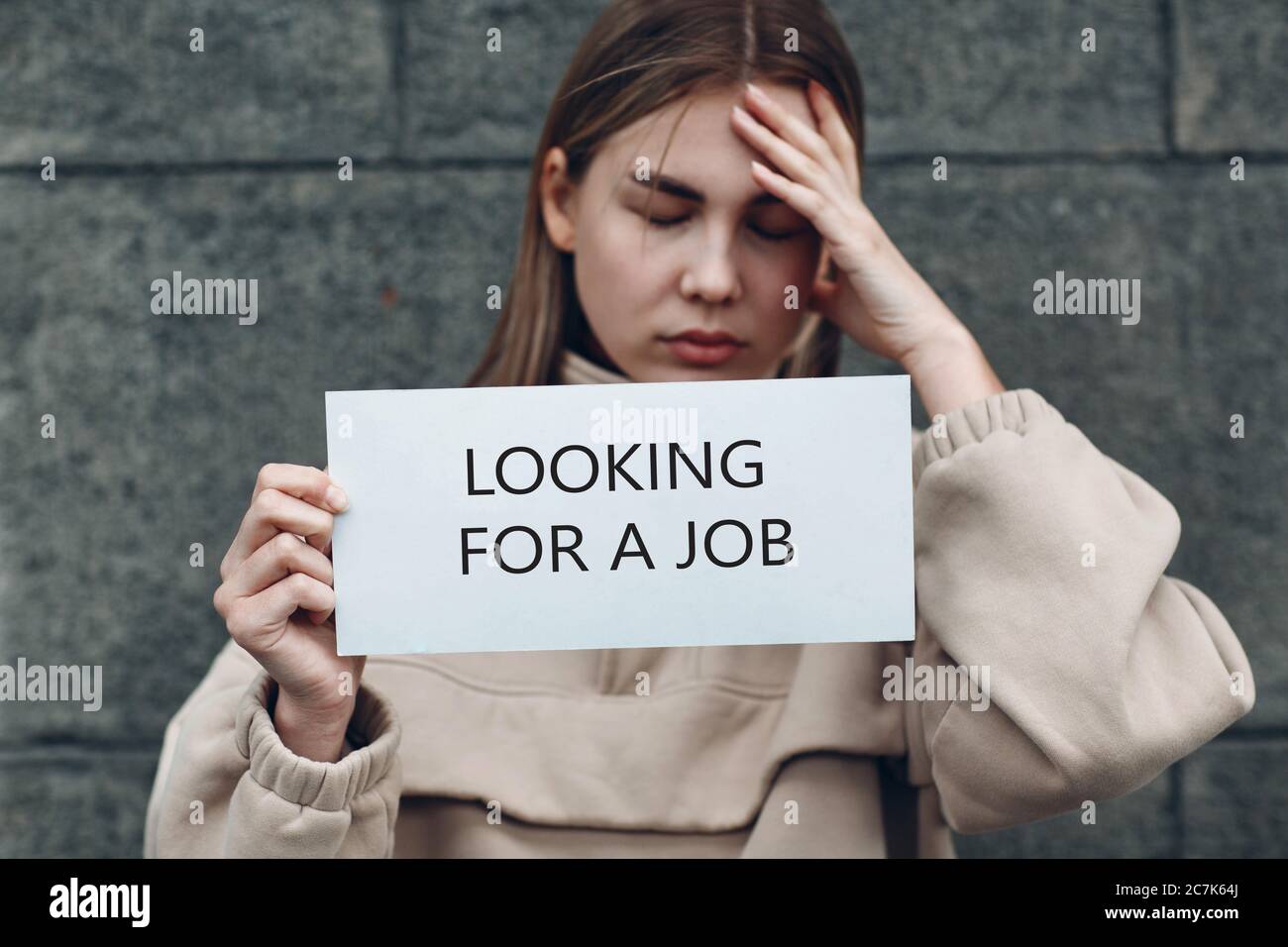 Young woman hold white paper poster in hand. Sad Girl with white blank ...