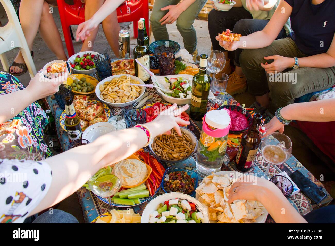 Full table view, people hands and eating process. Friends at the table ...