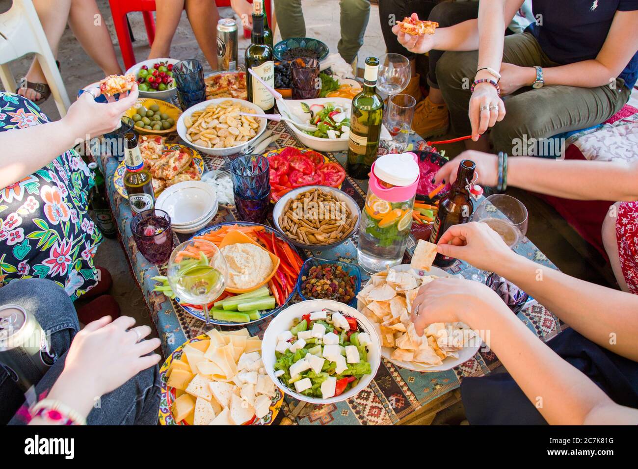 Full table view, people hands and eating process. Friends at the table ...