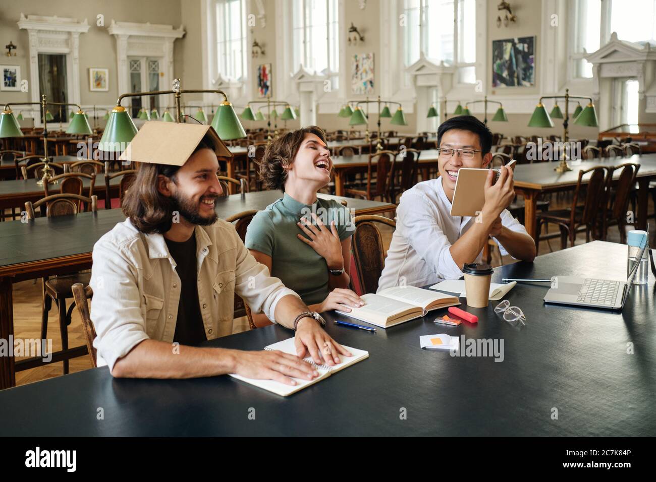 Group of young happy multinational students joyfully fooling around ...