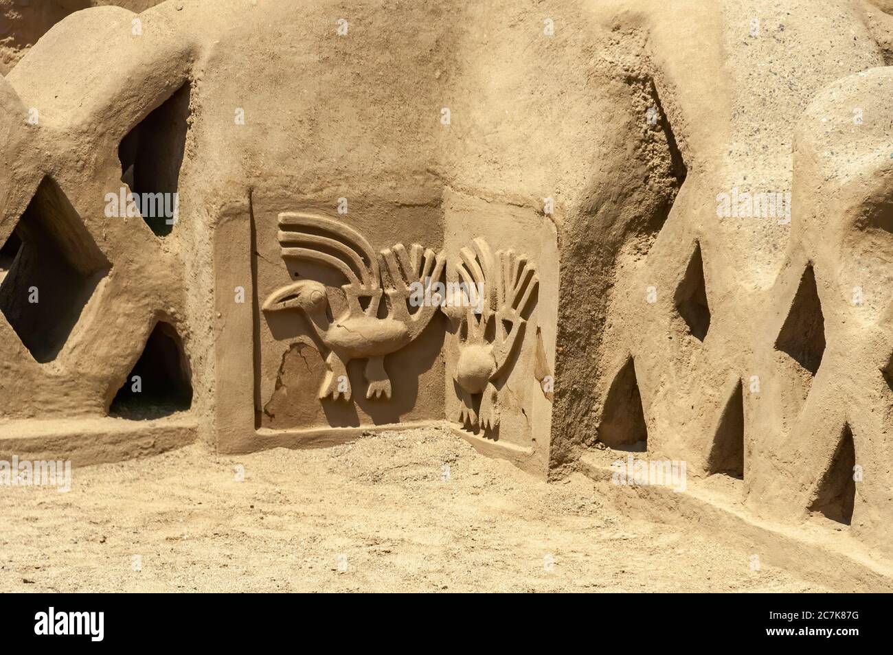 Detail of an adobe wall with a animal ssymbol design in the Chan Chan ...
