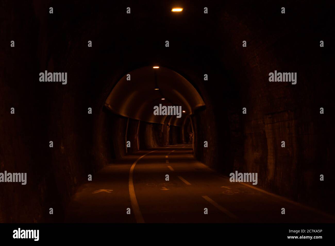 Dark pedestrian and bicycle lane in tunnel Stock Photo - Alamy