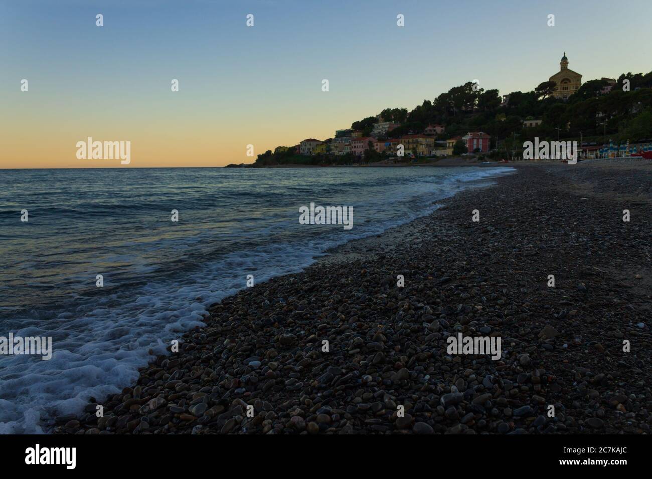 Sunset on a beach in Bussana, Liguria, Italy Stock Photo - Alamy