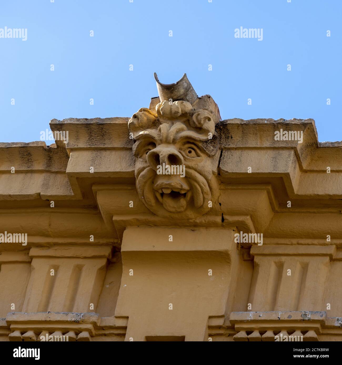 The grotesque face of a gargoyle on the 18th century Hospital del ...