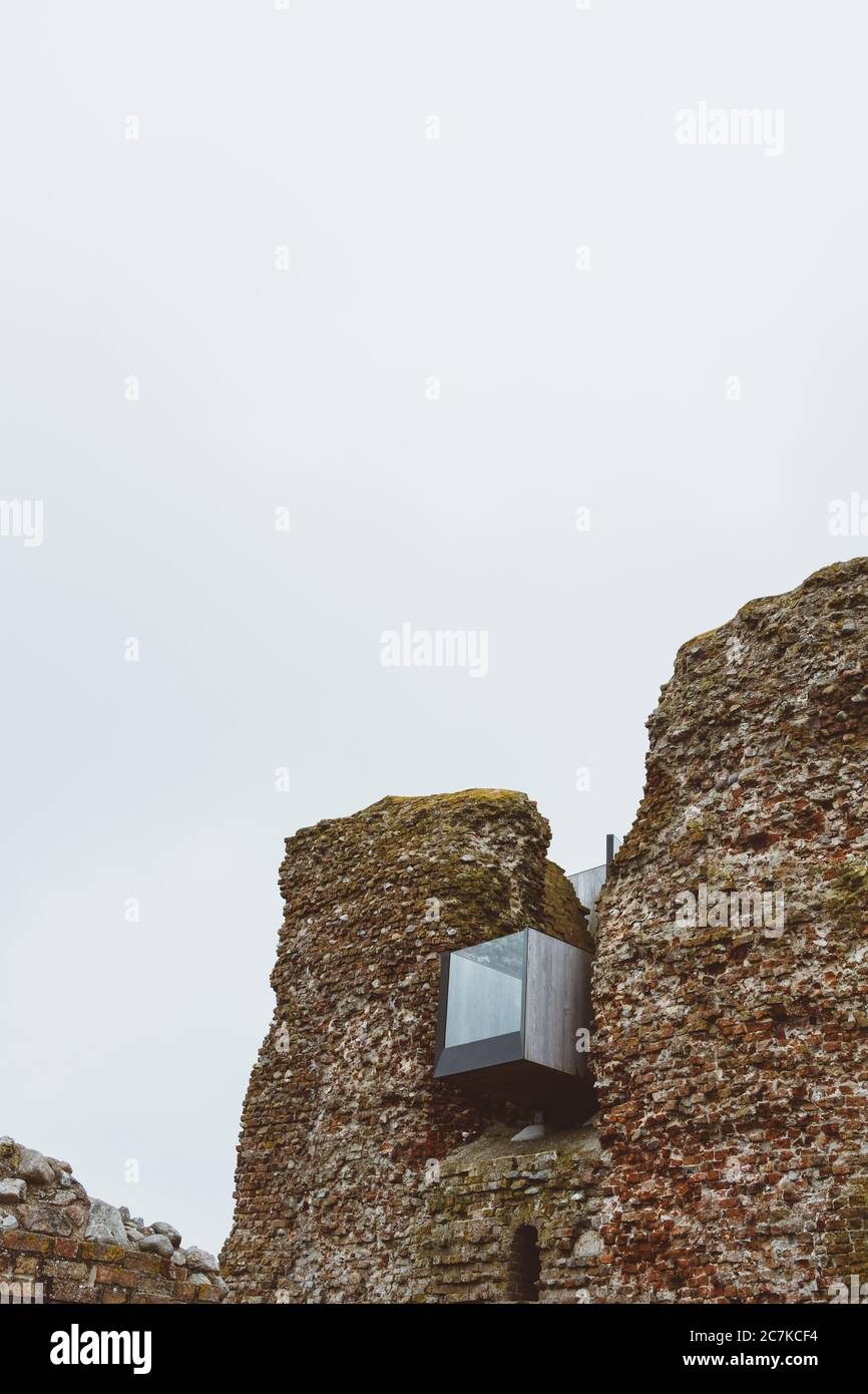 Compartment made of wood and glass stuck between two large rocks Stock ...