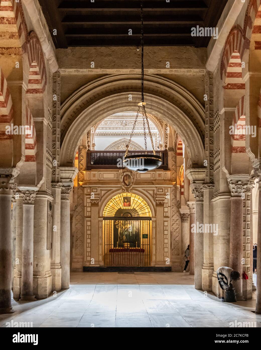 A passage between the double-tiered arches of Codoba Cathedral leads to ...