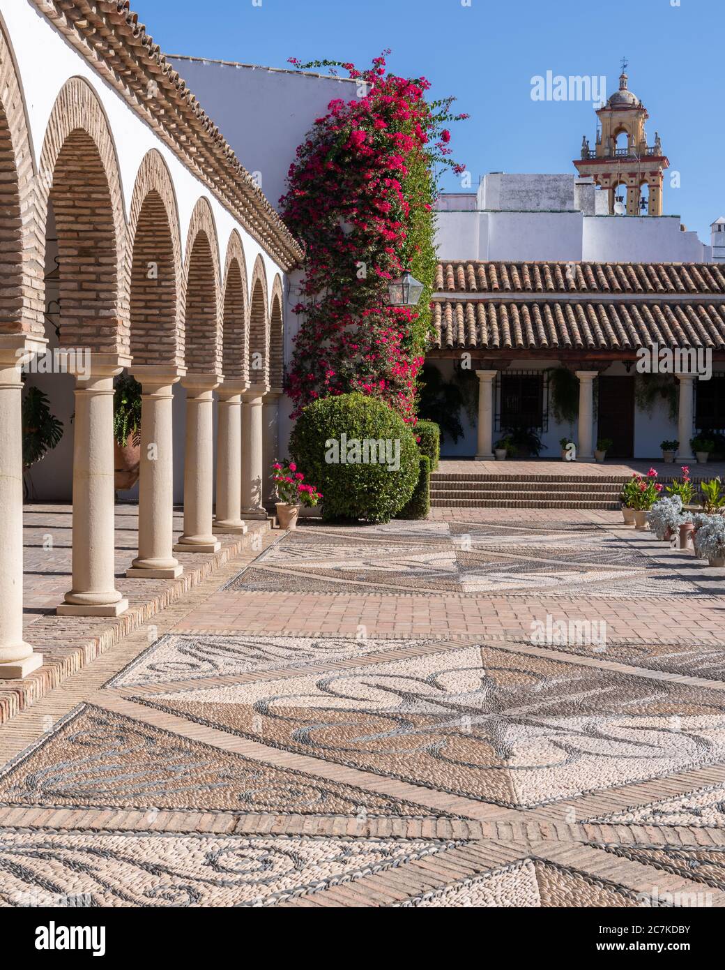 A brick arcade on stone columns lines the northwest edge of the ...