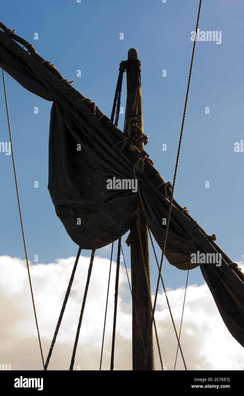 Vertical shot of the dark masts of a ship with the sky in the ...