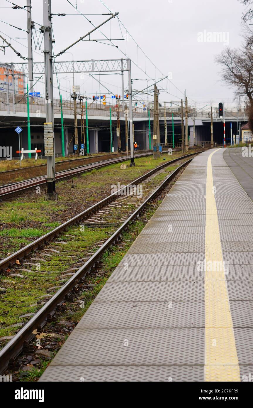 POZNAN, POLAND - Jan 13, 2020: Train tracks along a walking platform in ...