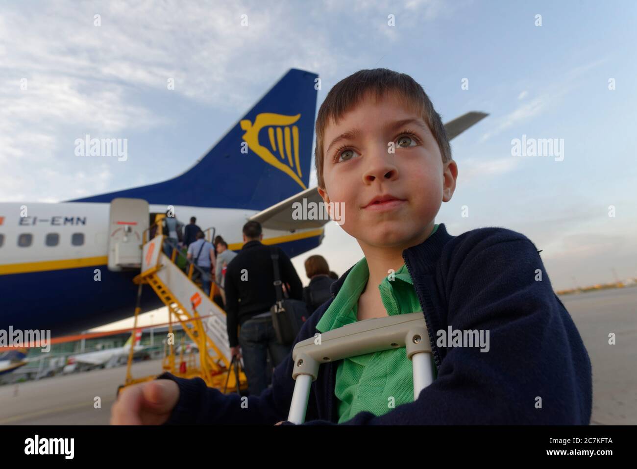 kid getting in a plane at the airport Stock Photo - Alamy