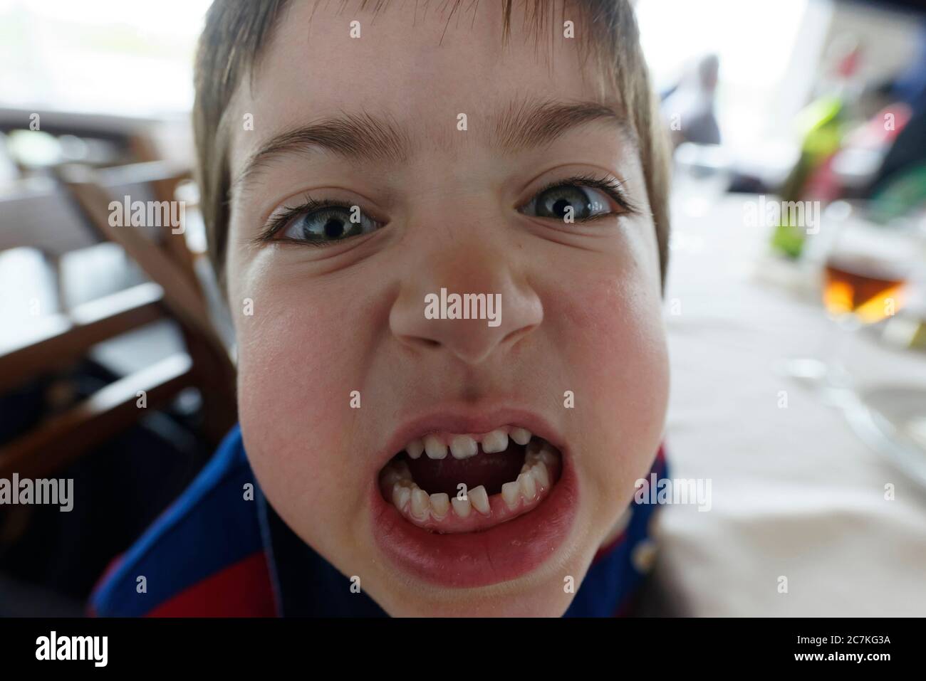 six years old kid showing off his teeth Stock Photo - Alamy