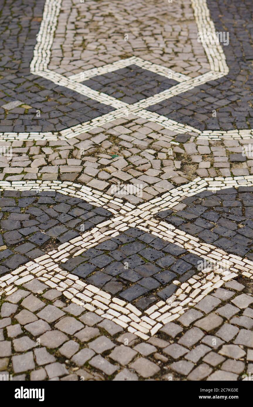 Vertical high angle closeup shot of a patterned cobblestone ground with ...