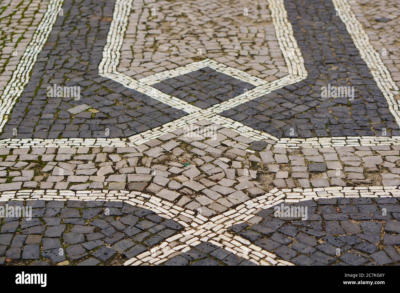 High angle closeup shot of a patterned cobblestone ground with tiles of ...