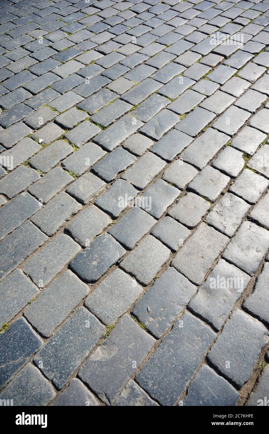 Vertical high angle closeup shot of a cobblestone ground with grey ...