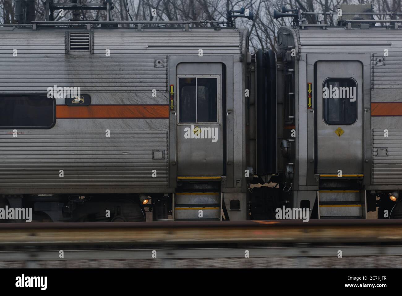 Profile of train running along its rails Stock Photo - Alamy