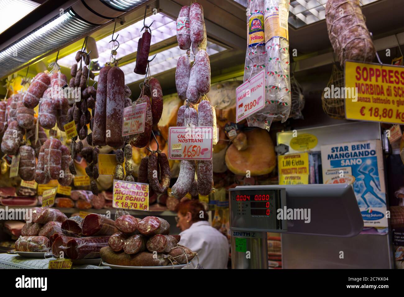 Woman selling meat in butcher shop in loggia of Palazzo della Ragione ...