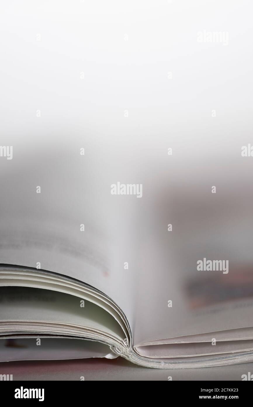 Open magazine on a table with narrow depth of field Stock Photo - Alamy