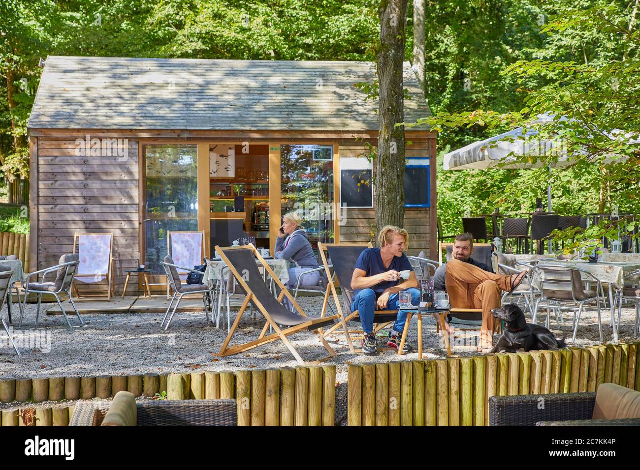 Two males drinking coffee in a small outdoor cafe in the countryside ...