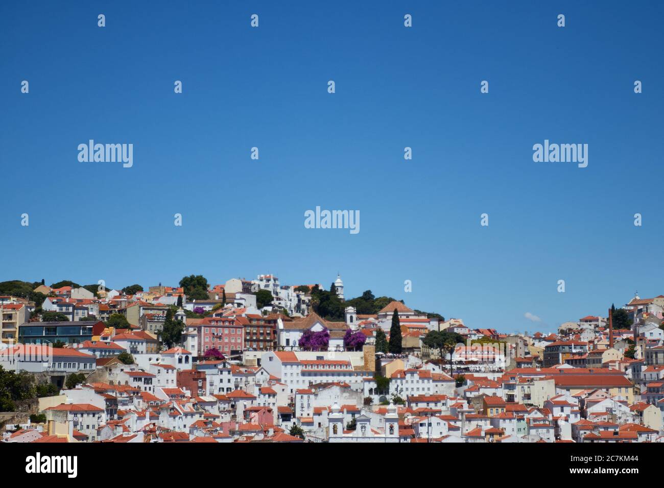 Horizontal wide shot of Lisbon Portugal city scape with a bright blue ...