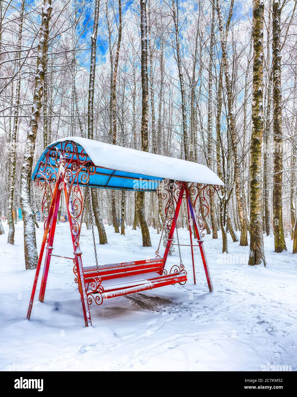 Empty swing in winter time with snow. Children's swing under a thick ...