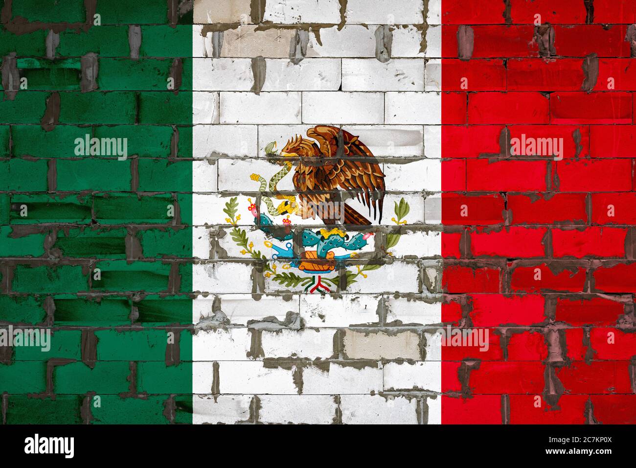 The national flag of Mexico painted on a wall of sibit blocks with ...