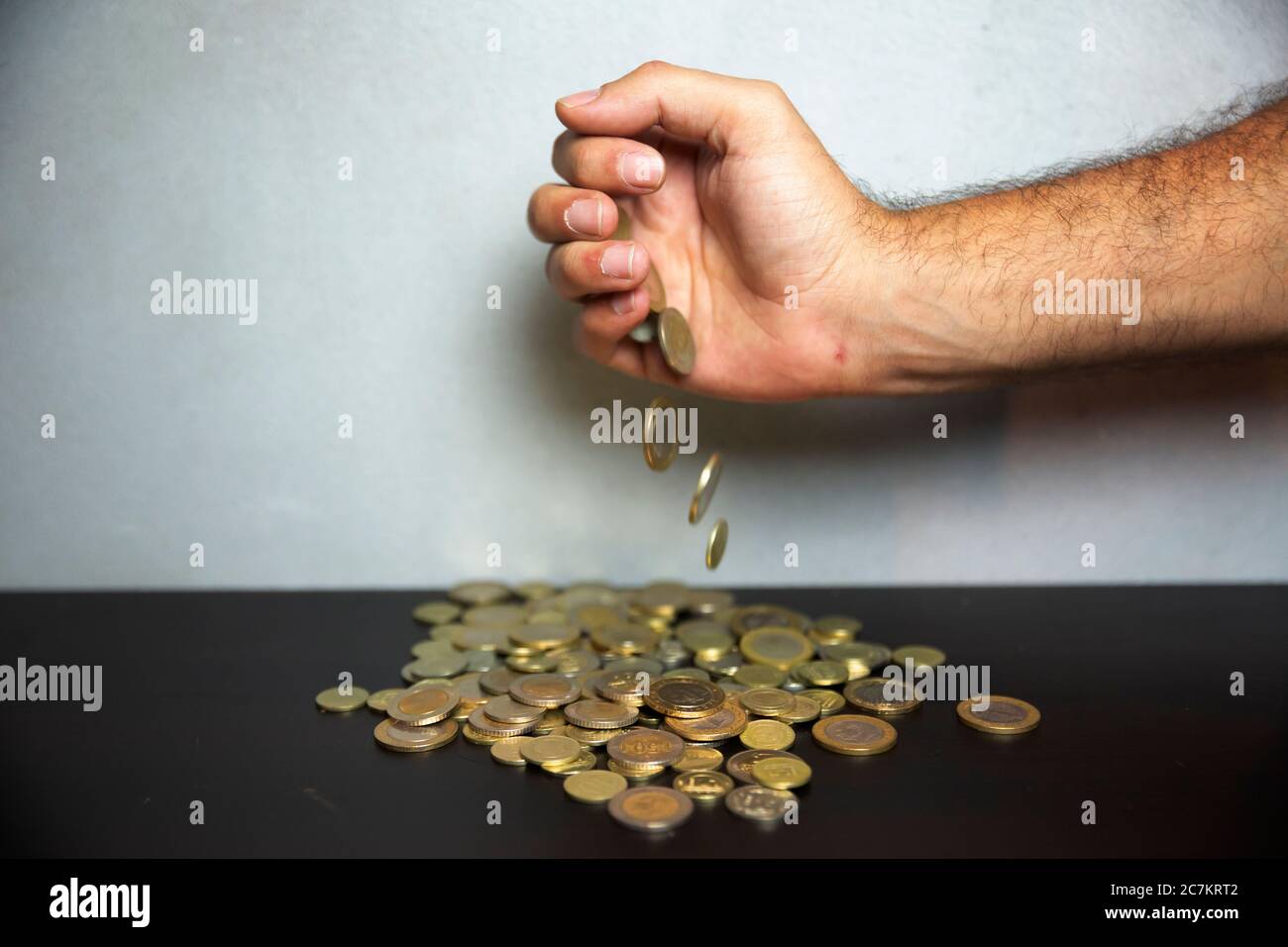 Man hand holding coin, selective focus Stock Photo - Alamy
