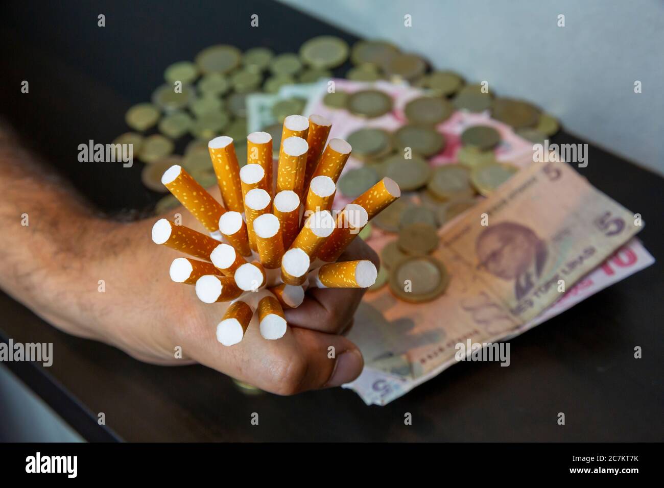hand holding cigarette and money backgrounds Stock Photo - Alamy
