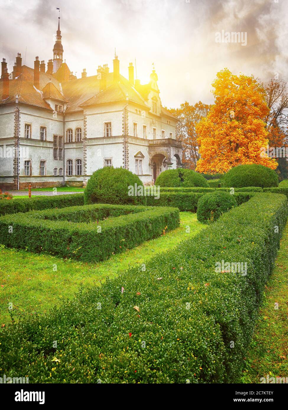 ancient castle in autumn. green lawn. Dramatic sky Stock Photo - Alamy